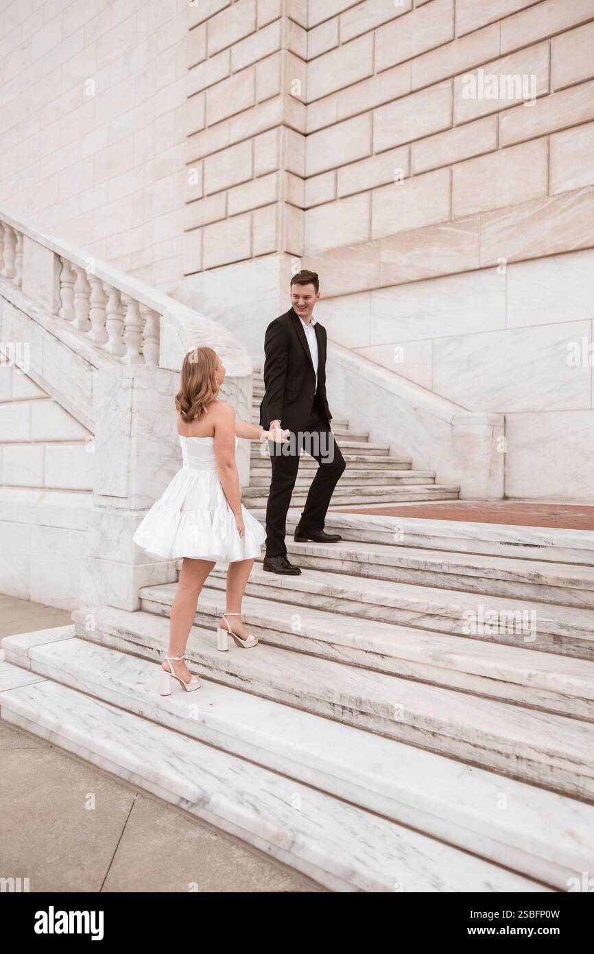 Couple in formal attire walking up the steps at the DIA Stock Photo - Alamy