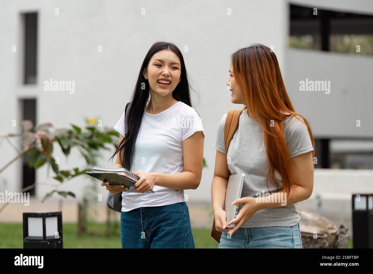 Diverse university students walking and laughing together on campus Stock Photo - Alamy