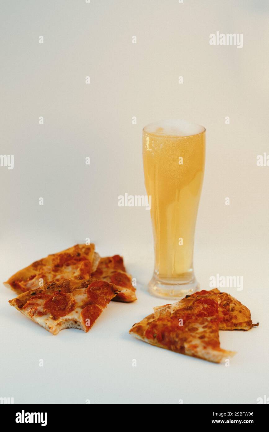 Glass of beer with pepperoni pizza slices Stock Photo - Alamy