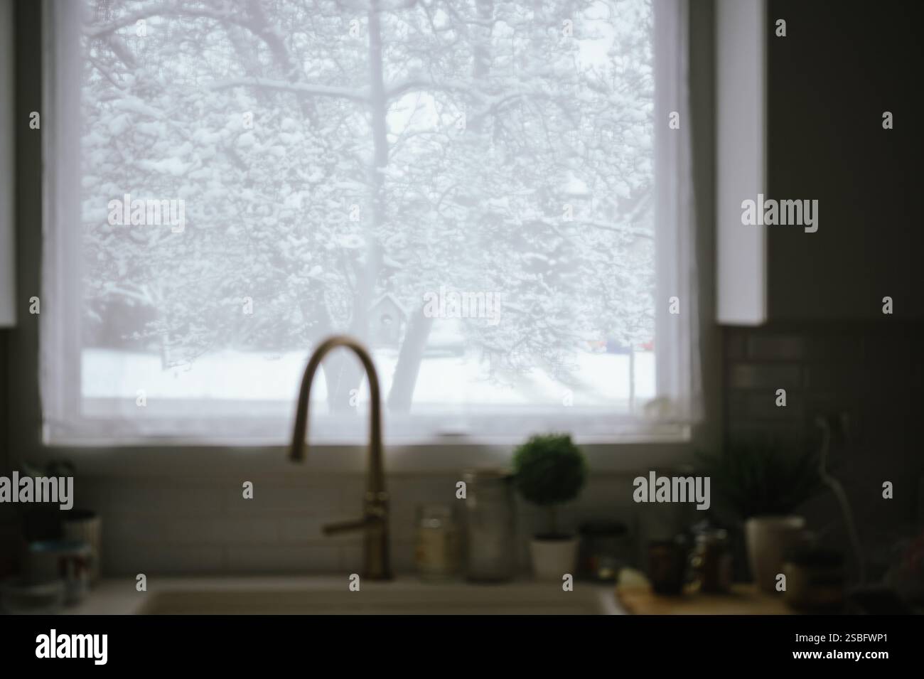 Snowy morning view from a kitchen window with a cozy ambiance Stock ...