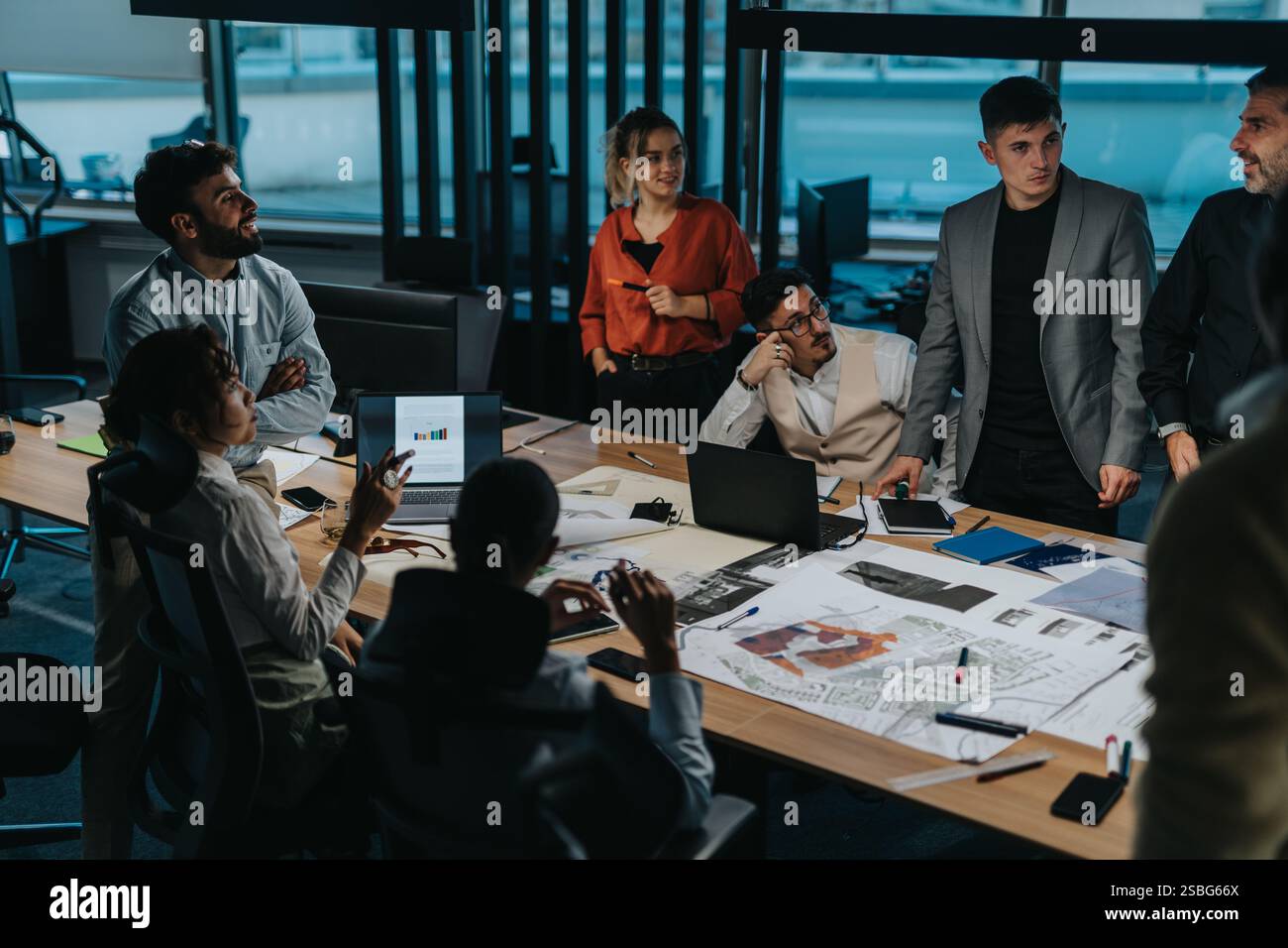 Multicultural and multigenerational group of business colleagues engage in a creative ...