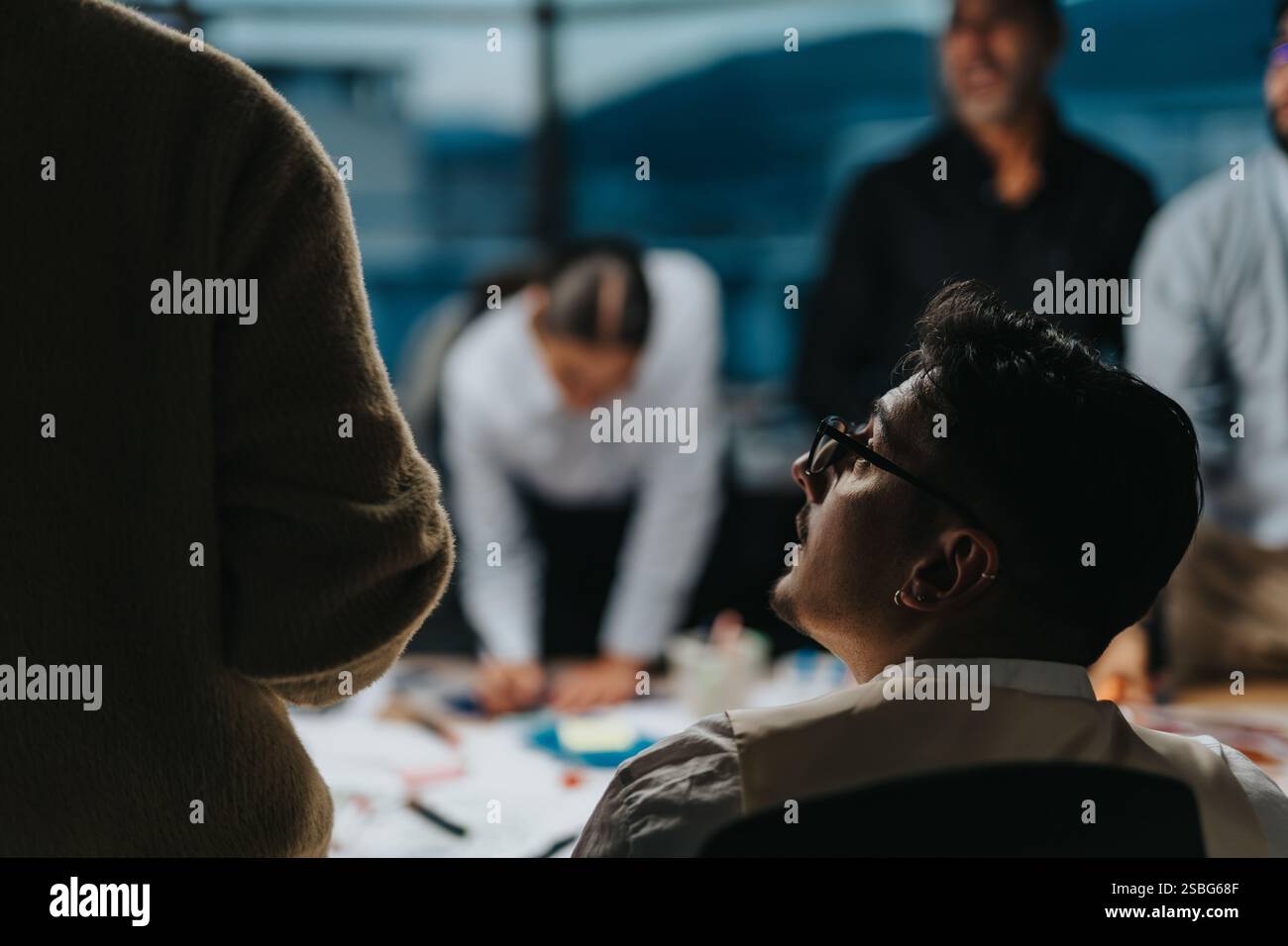 Colleagues engage in a brainstorming session, discussing project ideas and solutions late into ...