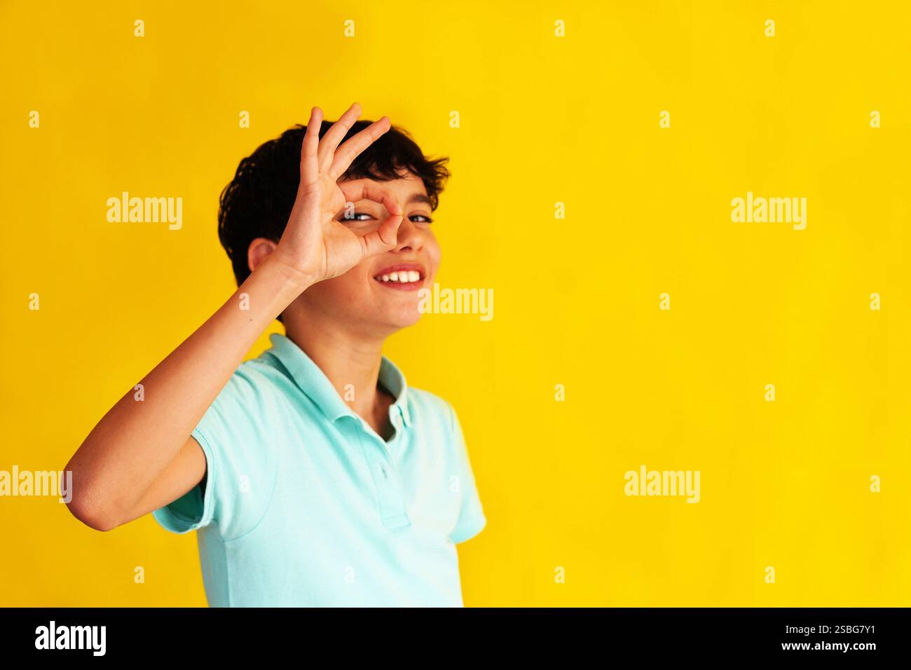 teenage boy making circle game gesture . looking through the circle ...