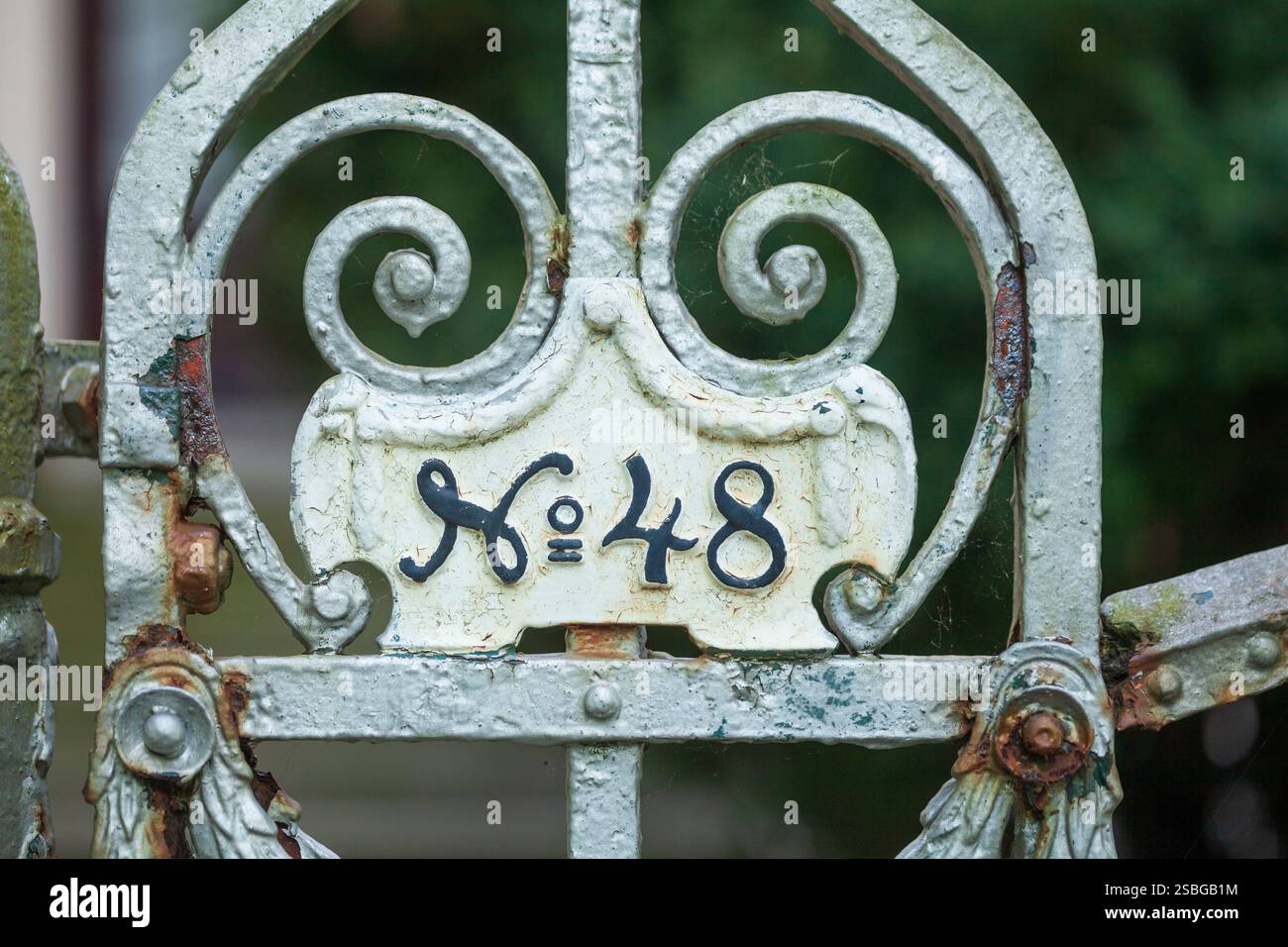 Old house license plate number forty-eight and decorated white metal ...