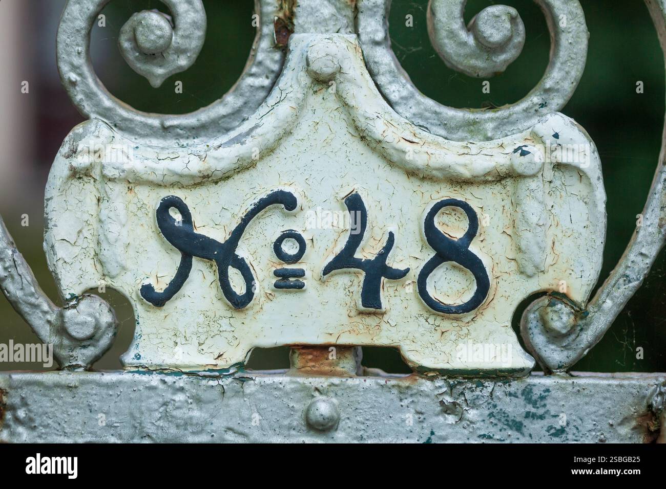 Old house license plate number forty-eight and decorated white metal ...