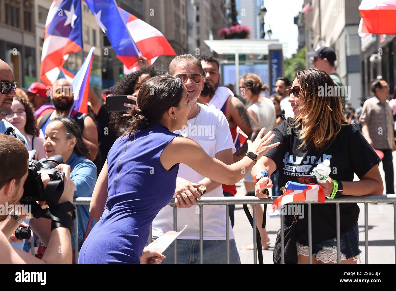 Alexandria Ocasio-Cortez marching in the National Puerto Rican Day ...