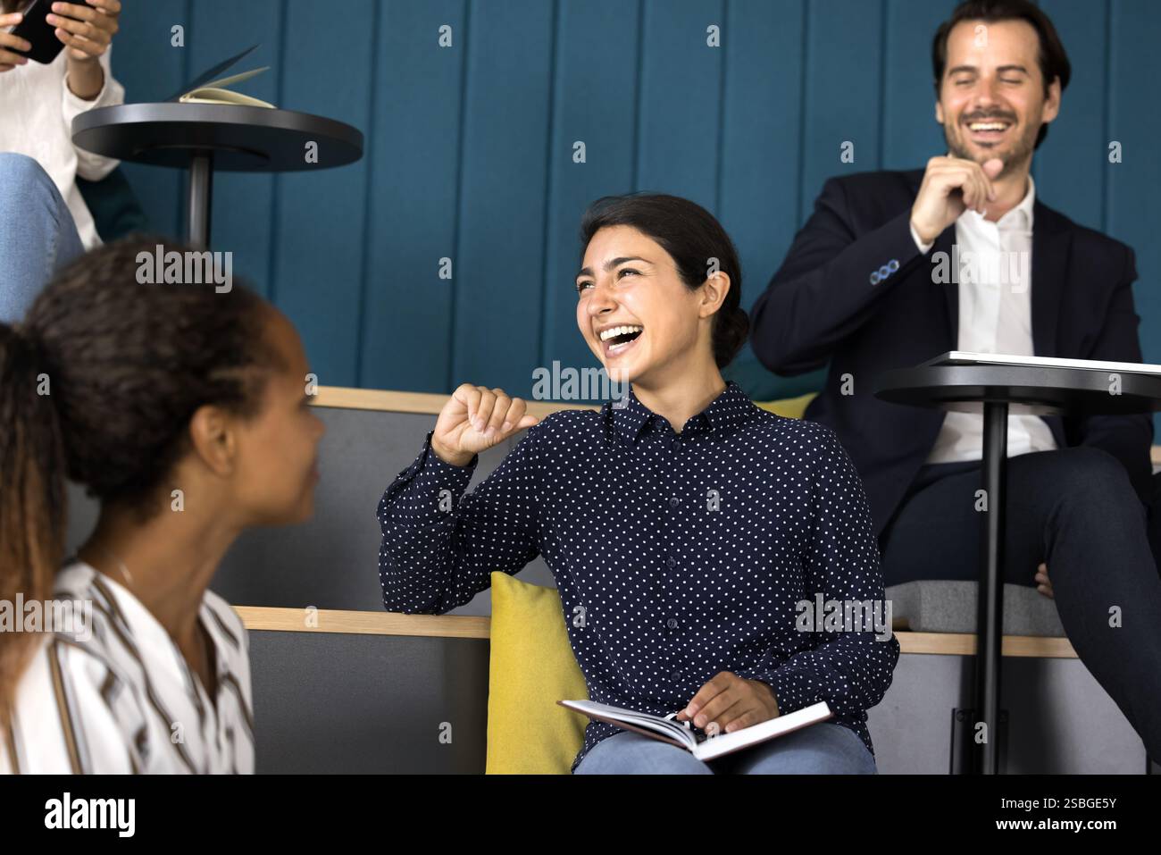 Group of professionals laughing, joking, sharing light-hearted moments ...