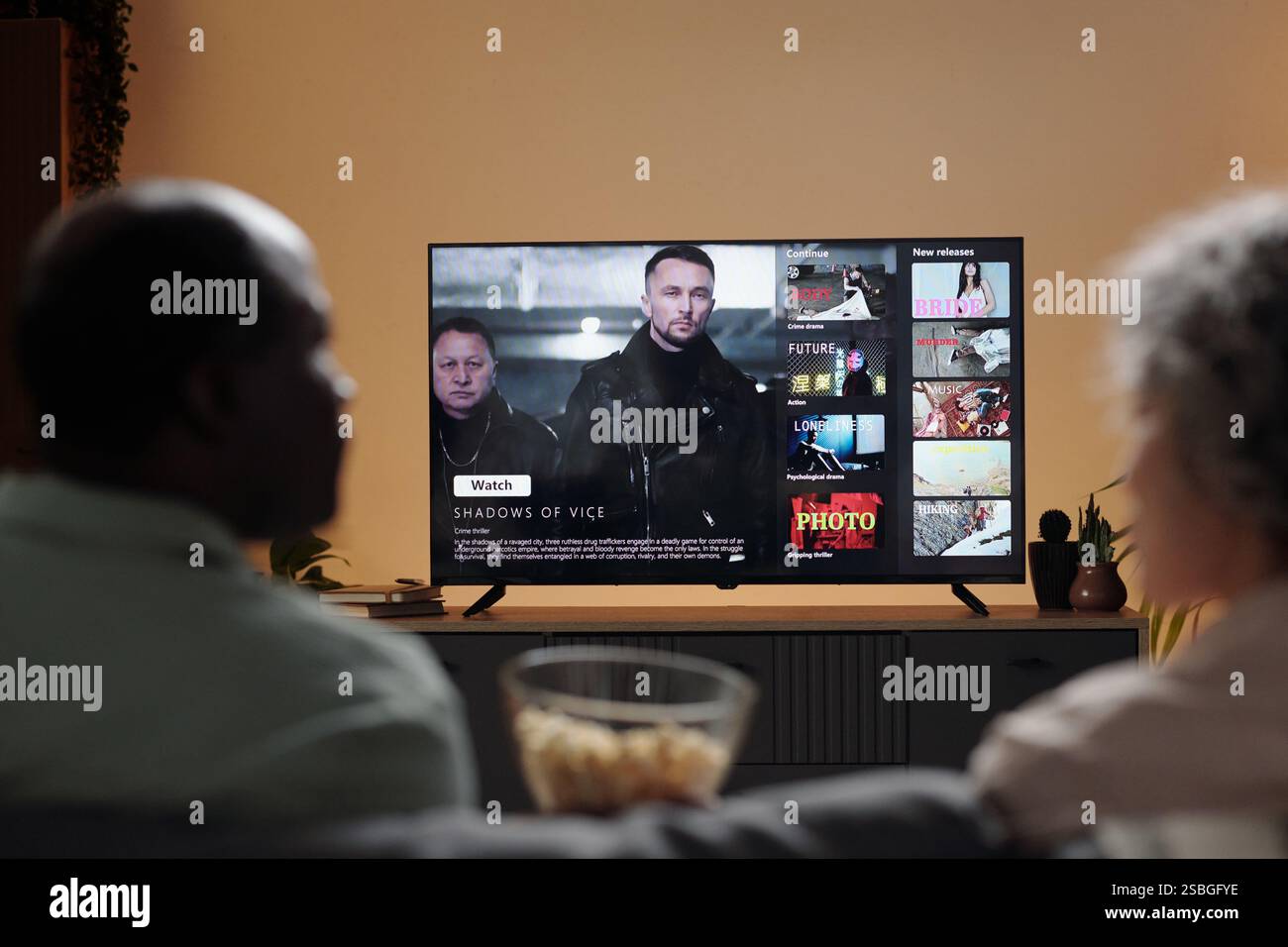 Watching Action Movie on Living Room TV Screen Stock Photo - Alamy