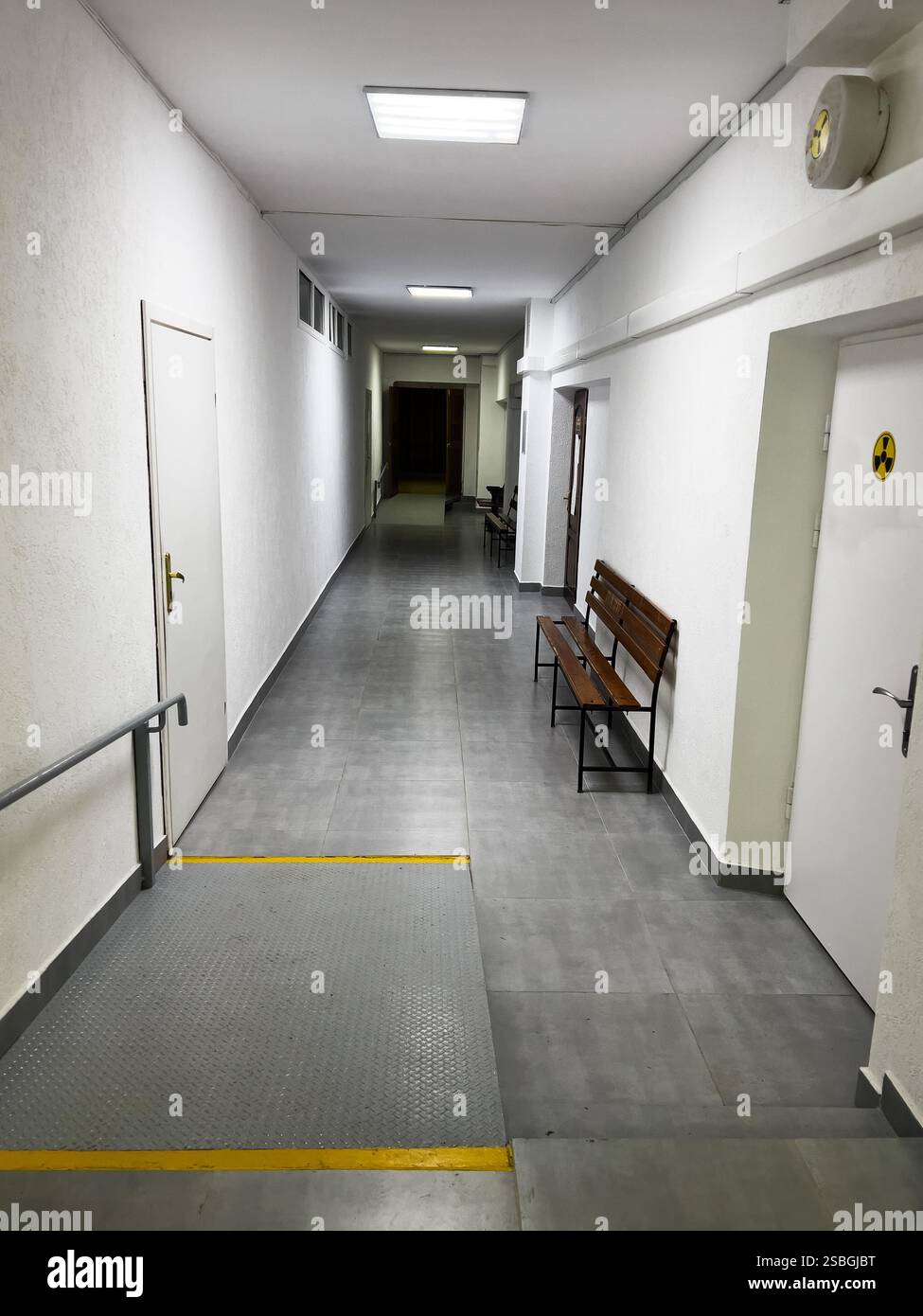 Modern hallway featuring benches along the wall, a safety zone entry ...