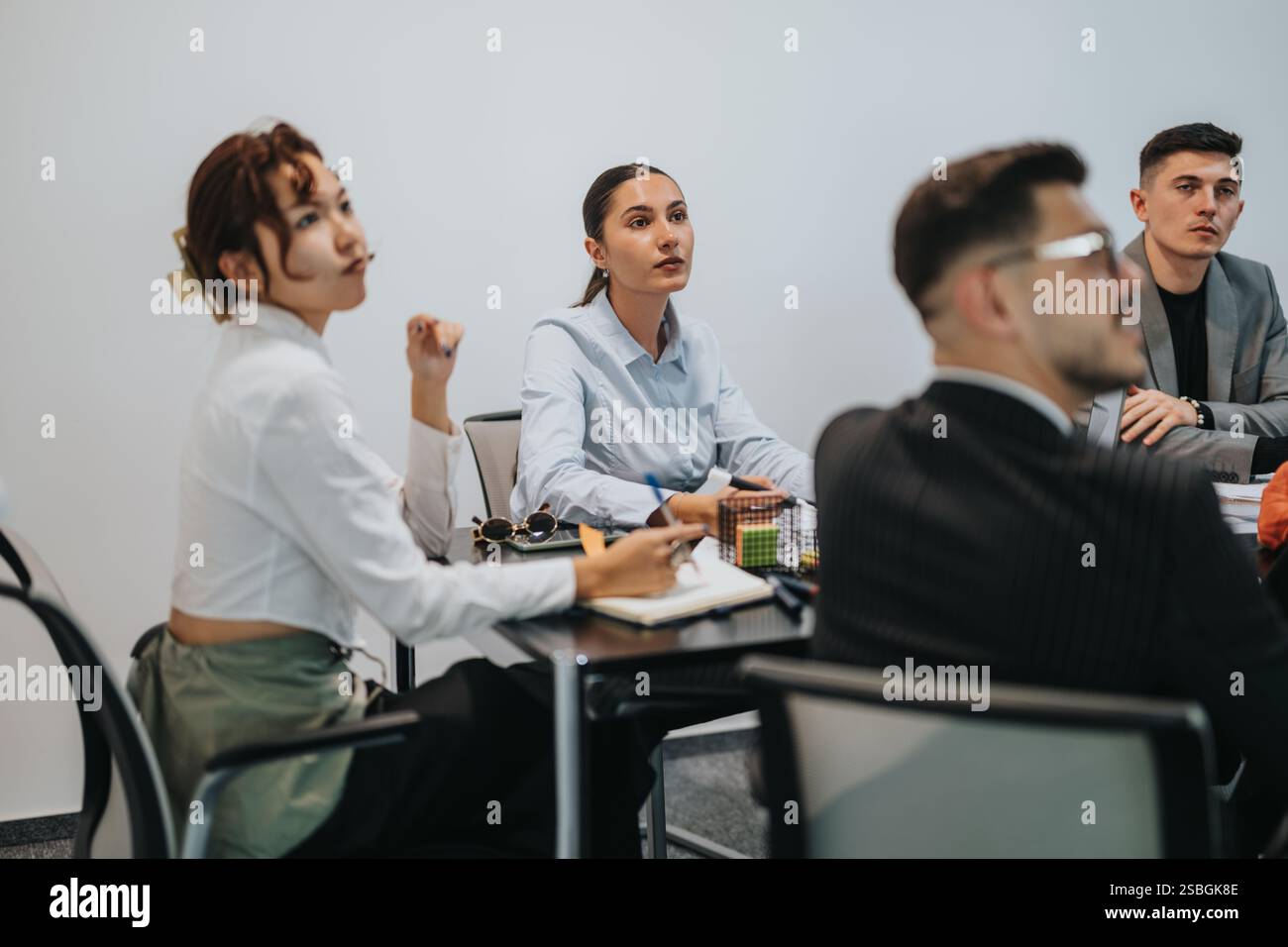 Focused multicultural business team in a meeting discussion Stock Photo ...