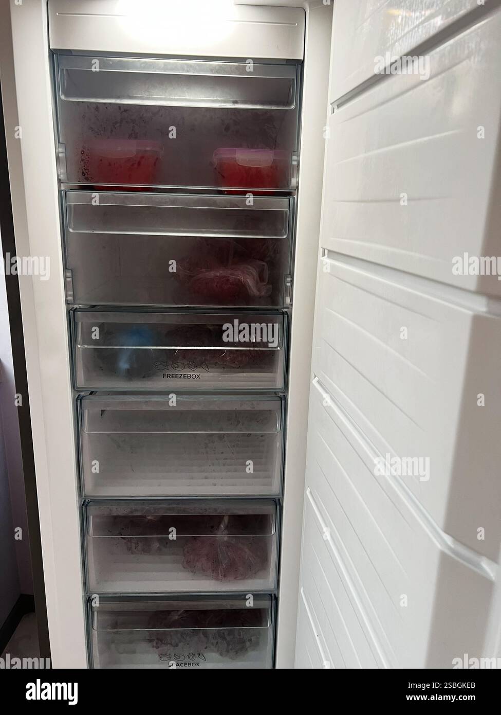Illustration of a modern upright freezer featuring transparent drawers ...