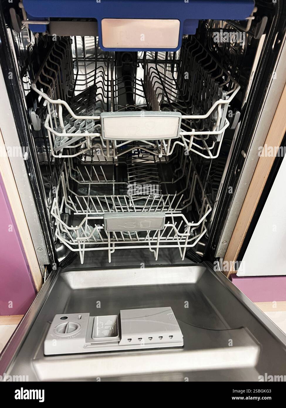 Empty dishwasher with stainless steel interior, open detergent ...
