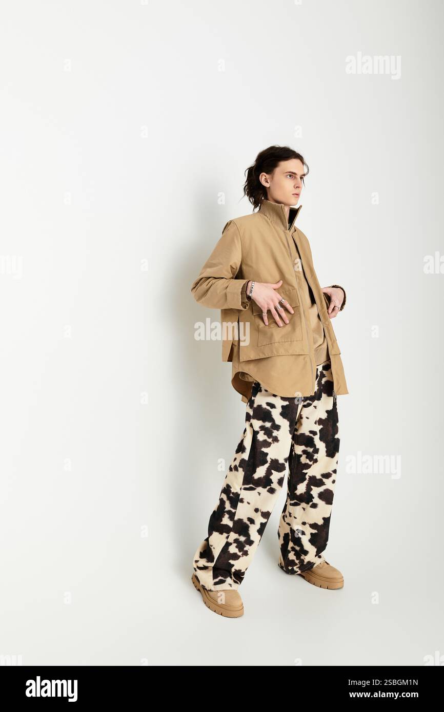 A stylish young man showcases a trendy outfit in a clean, confidence ...