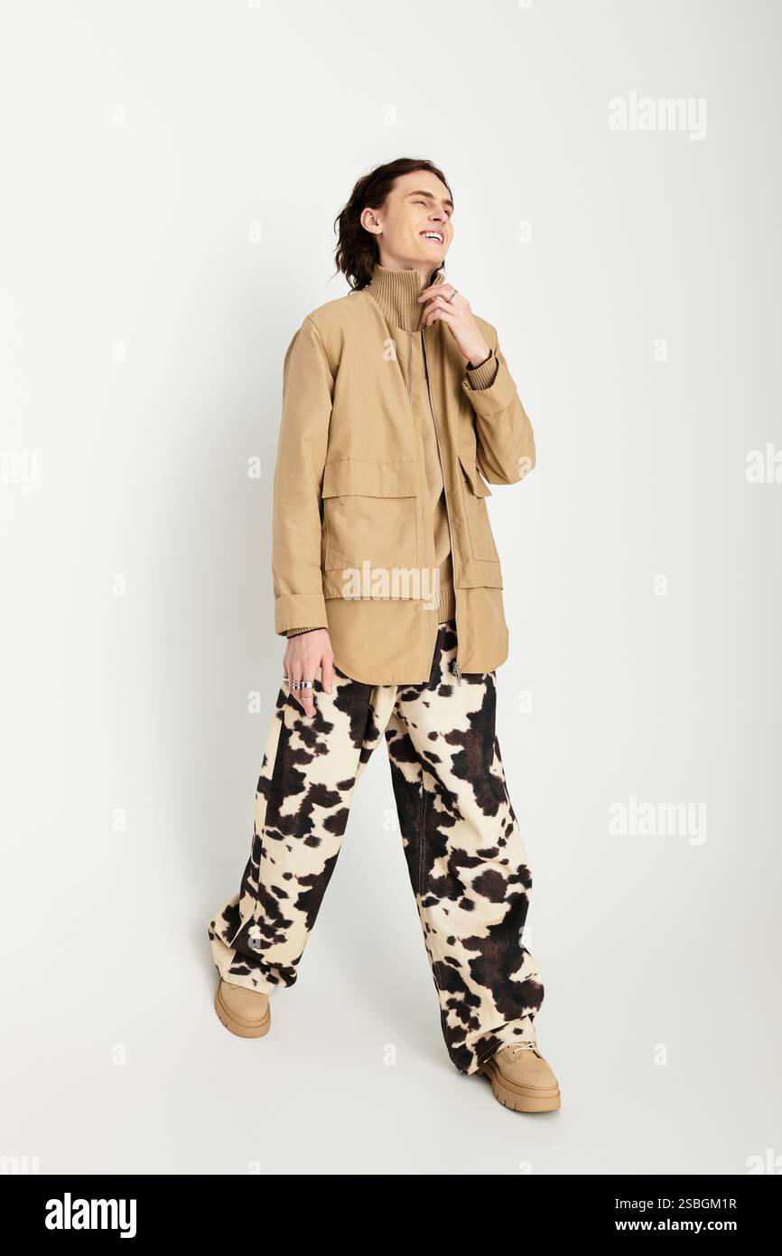 A handsome young man wears trendy clothing, blending comfort and style ...