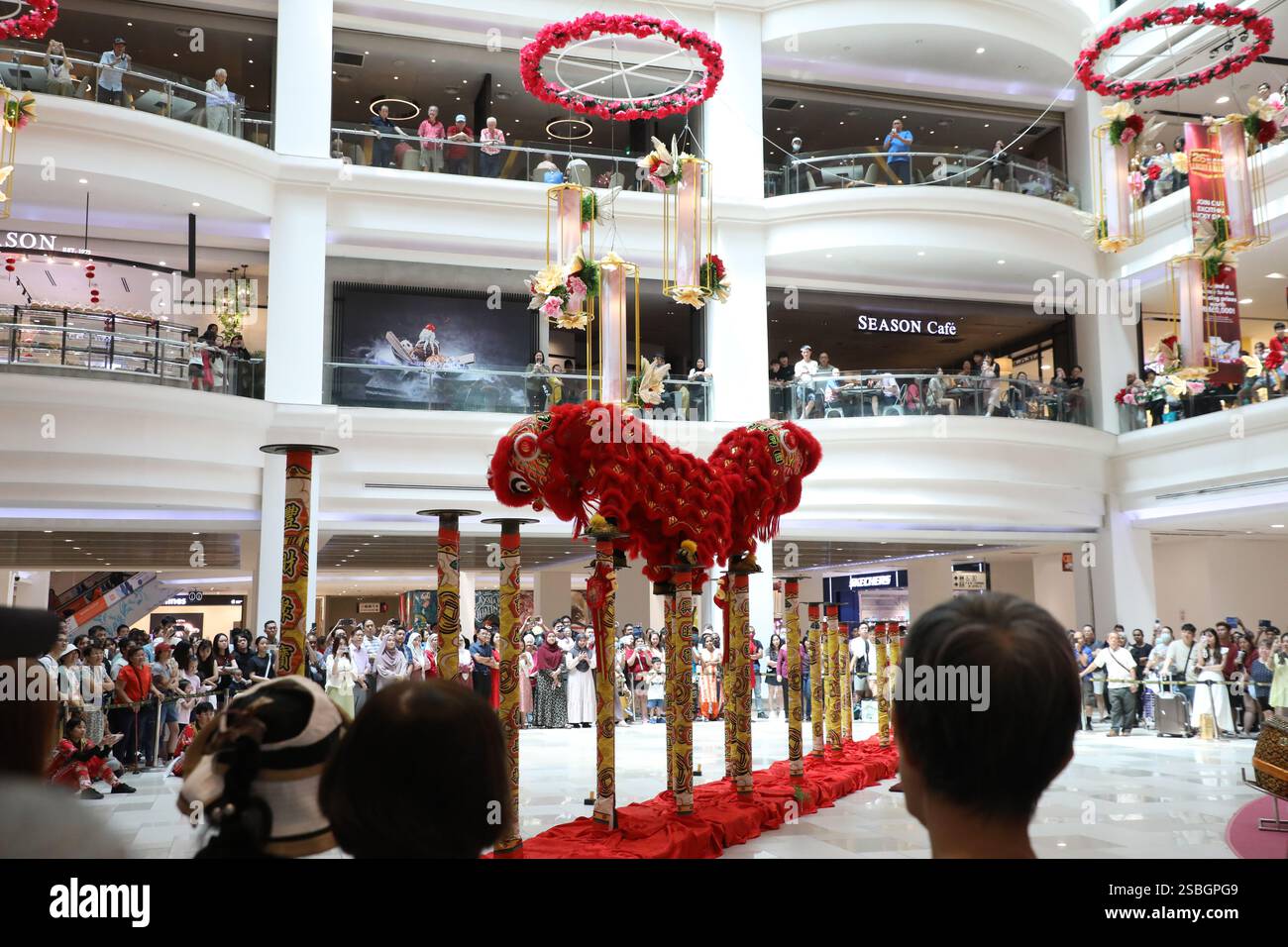 A lion dance performance on stilts at City Square shopping mall in ...