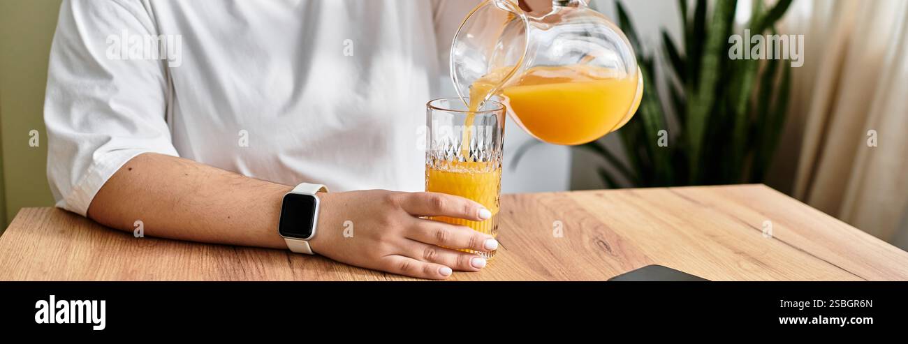 A beautiful young plus sized woman happily serves fresh juice into a ...