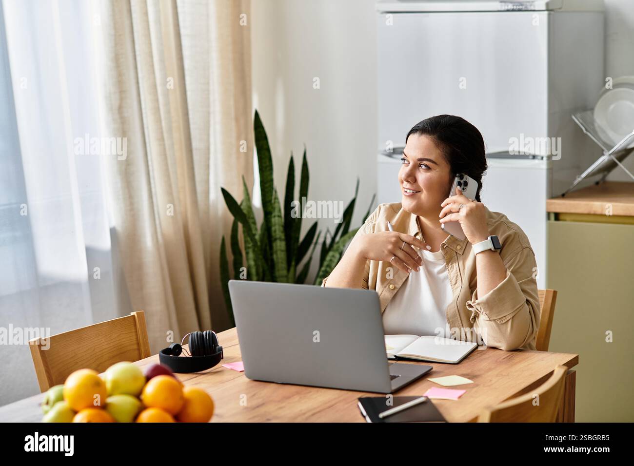 A charming young woman enjoys a lively phone conversation at her ...