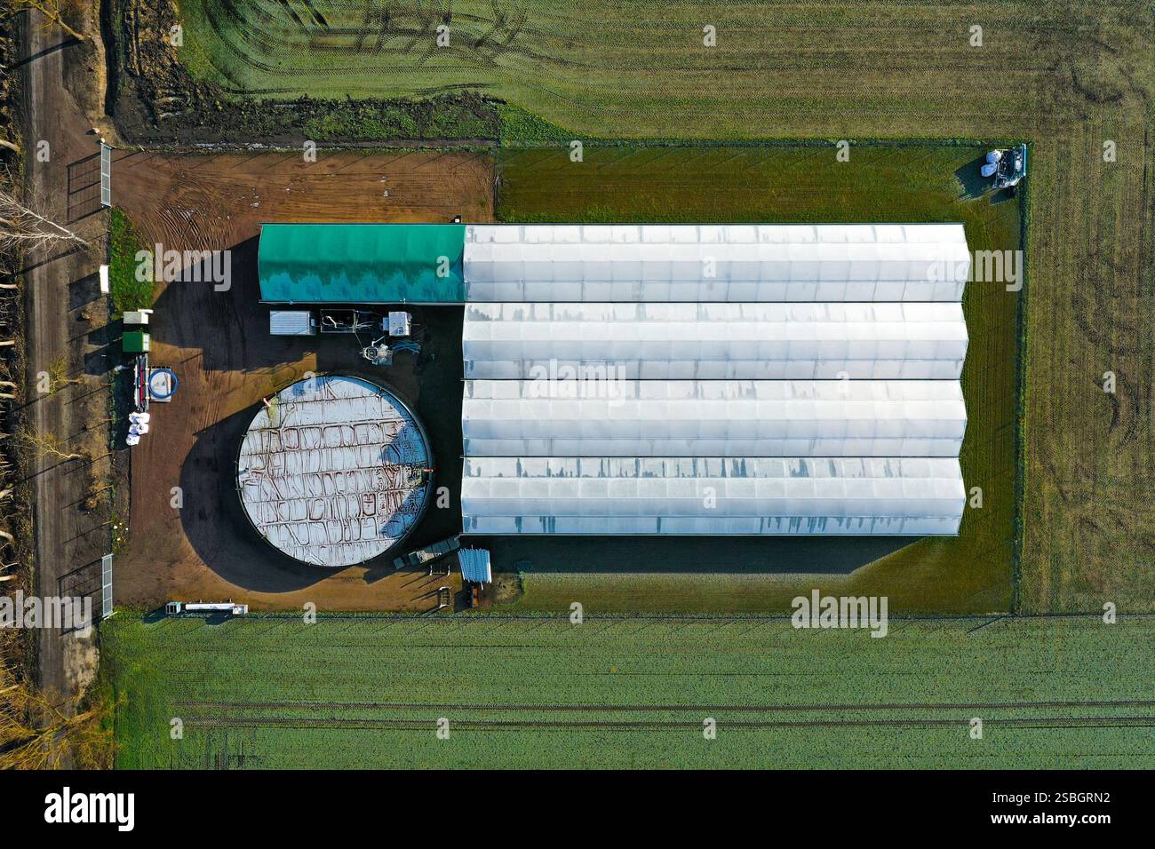 Aerial view reveals a modern agricultural complex featuring greenhouses ...