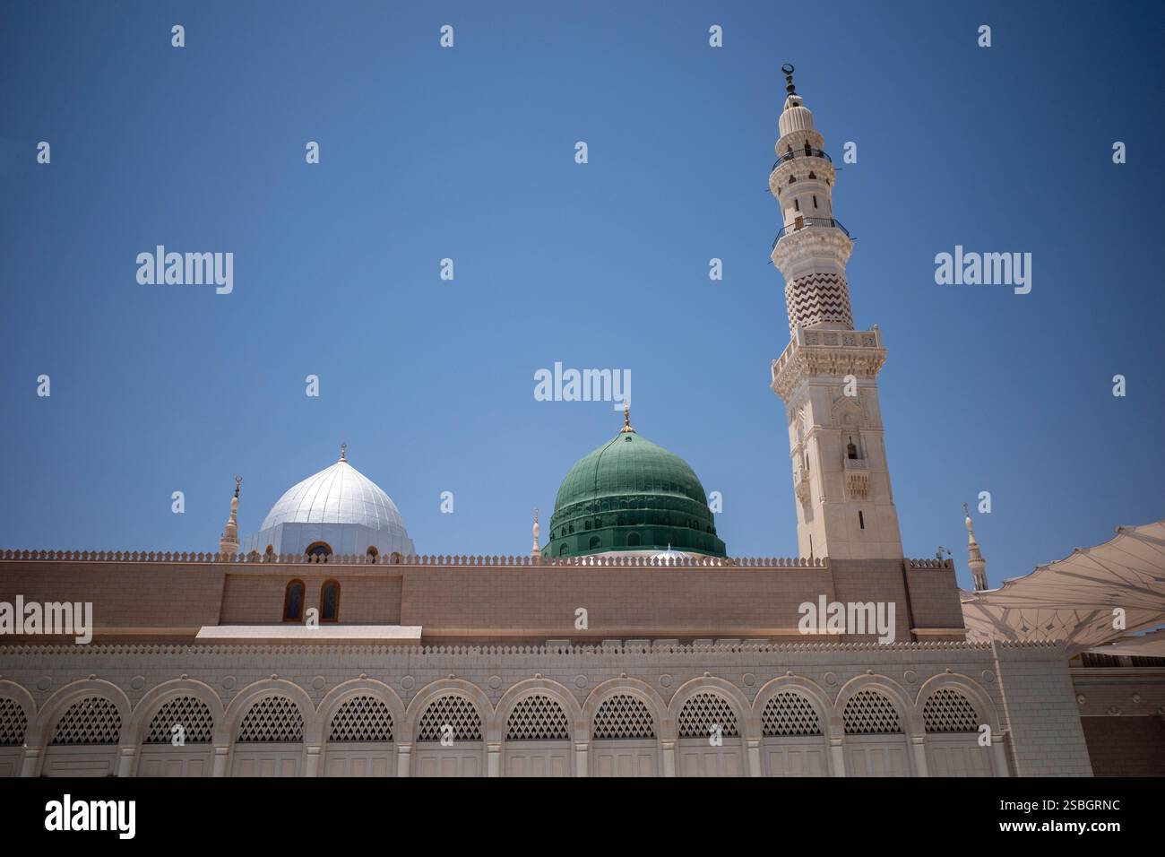 A green dome and minarets in Prophet Mosque in Madinah, also known as ...