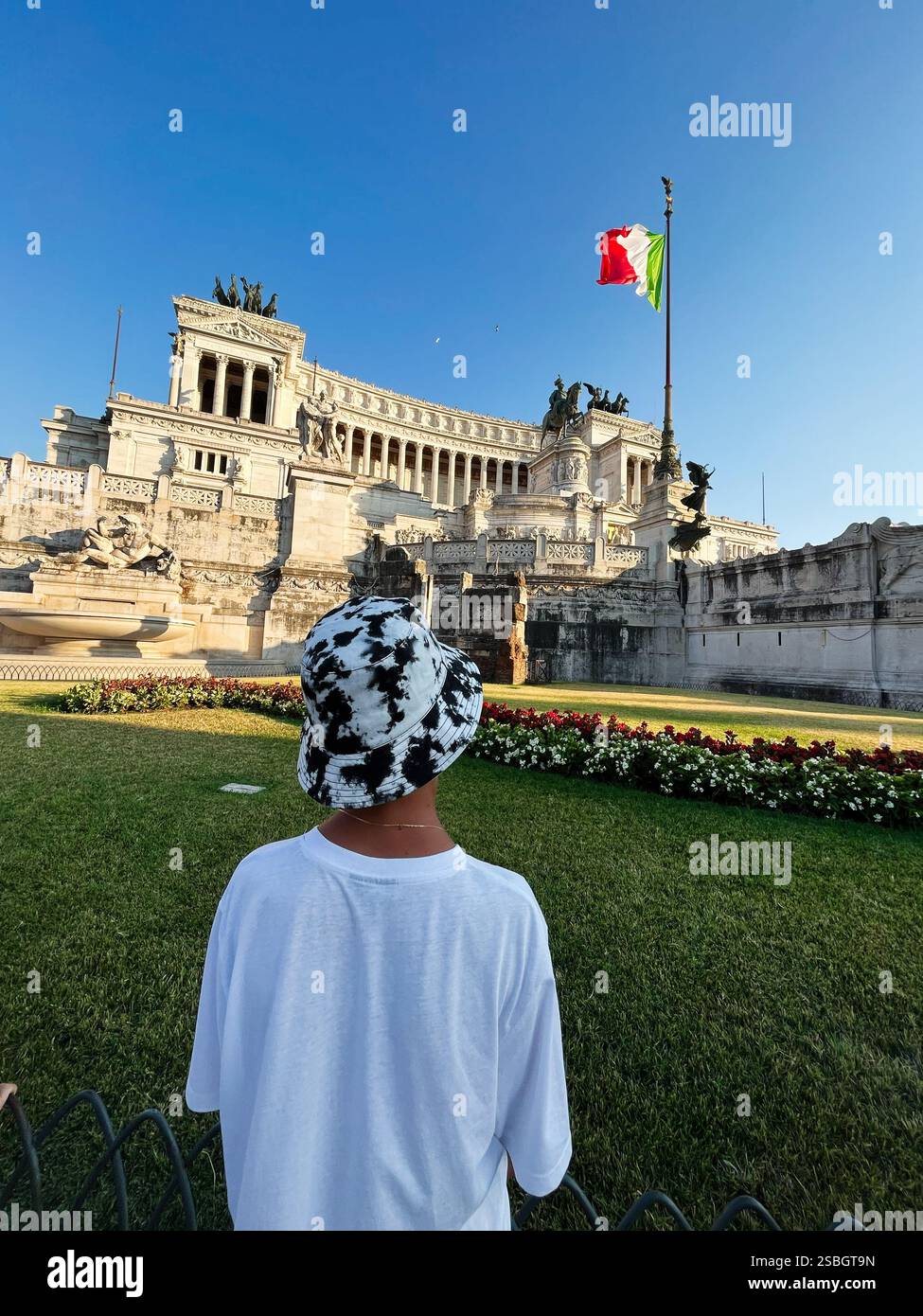 A person views a magnificent historic building with an Italian flag on ...
