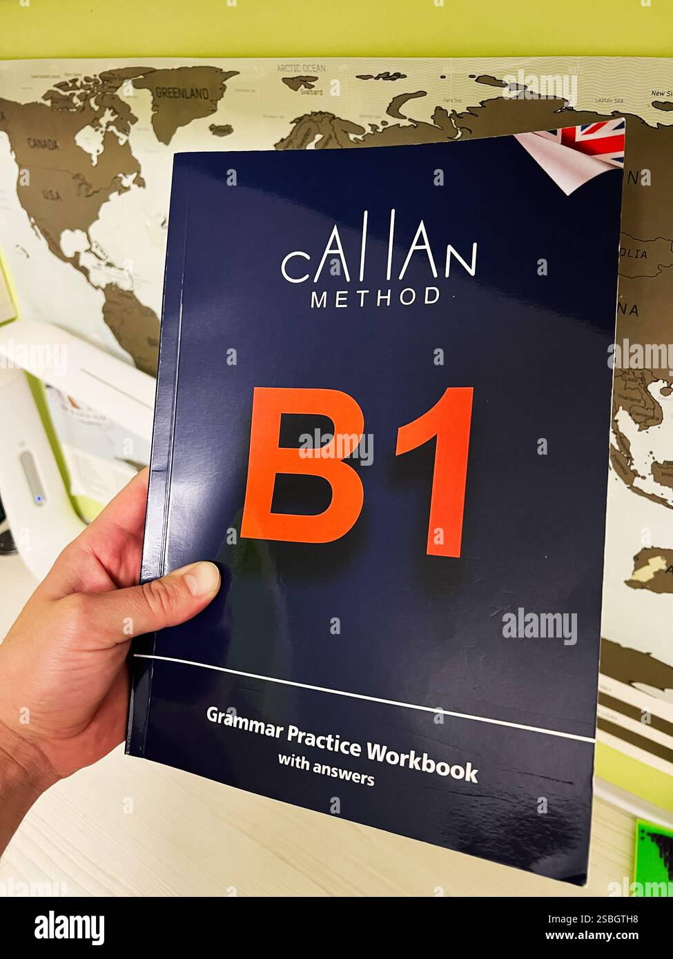 Kyiv, Ukraine - February 02, 2025: A person is holding a blue book ...