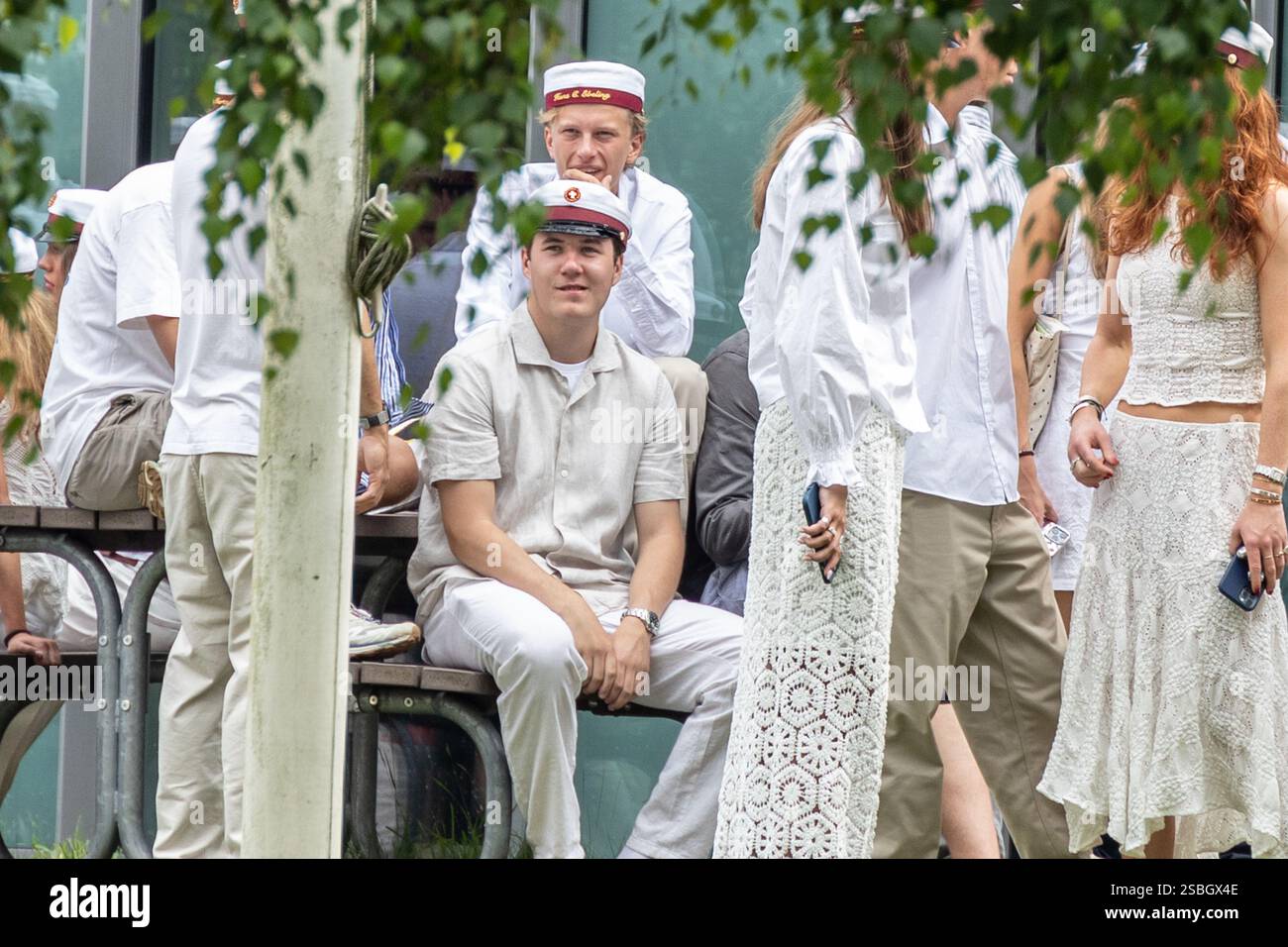 Crown Prince Christian seats on a bench at his graduation ceremony near ...
