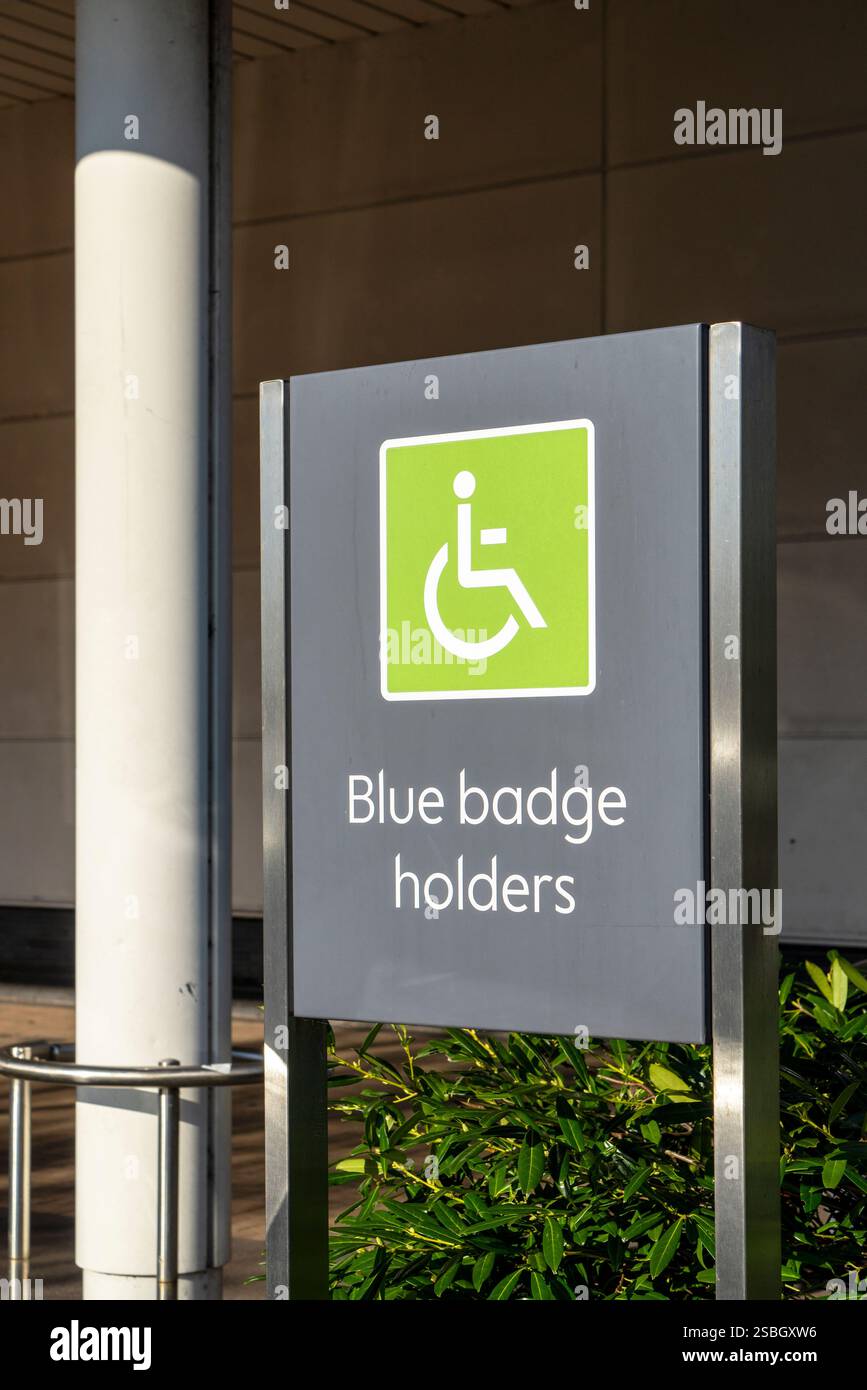 Disabled drivers blue badge holders parking bay sign Stock Photo - Alamy