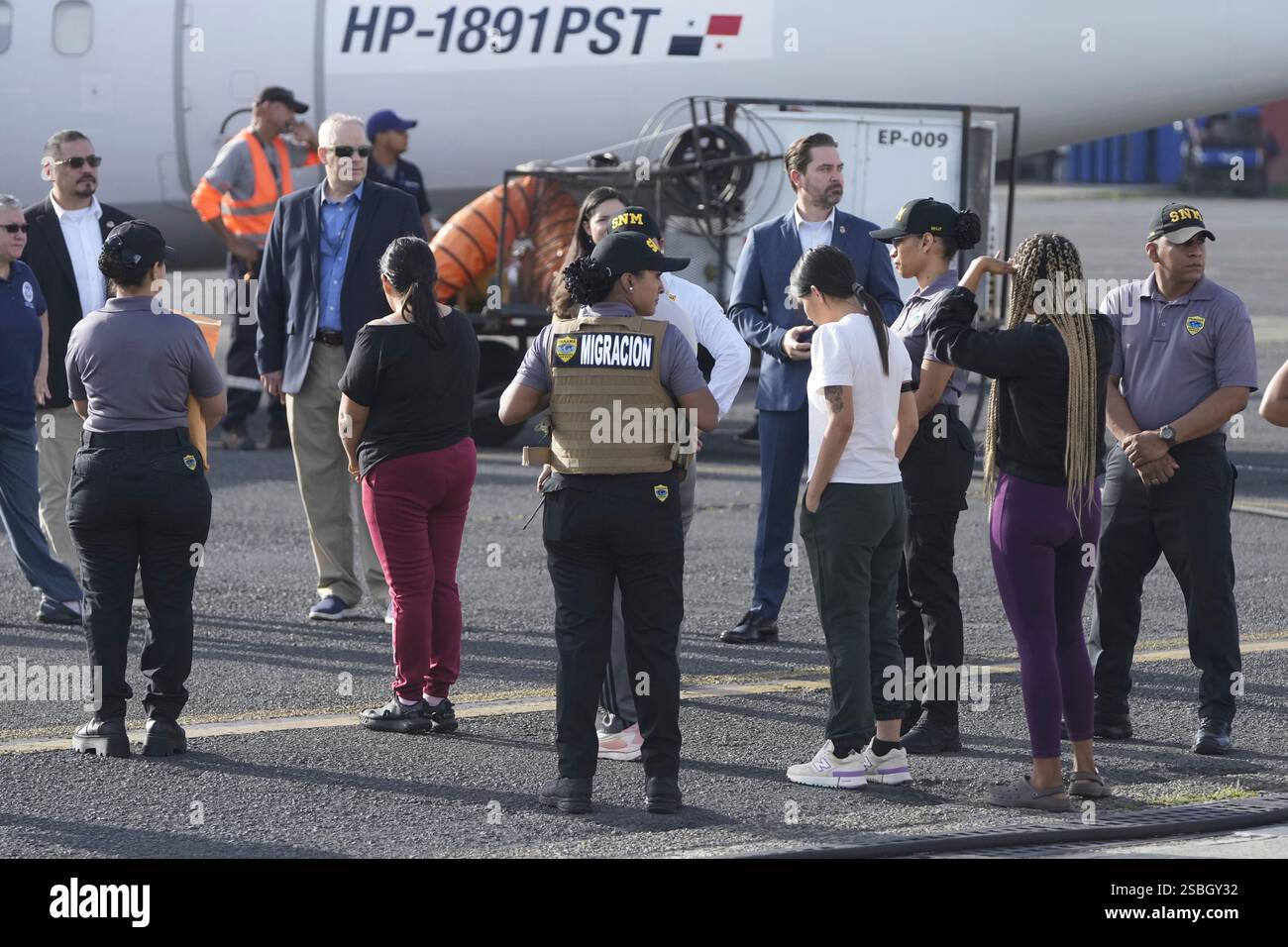 People line up to board a repatriation flight bound for Colombia at ...