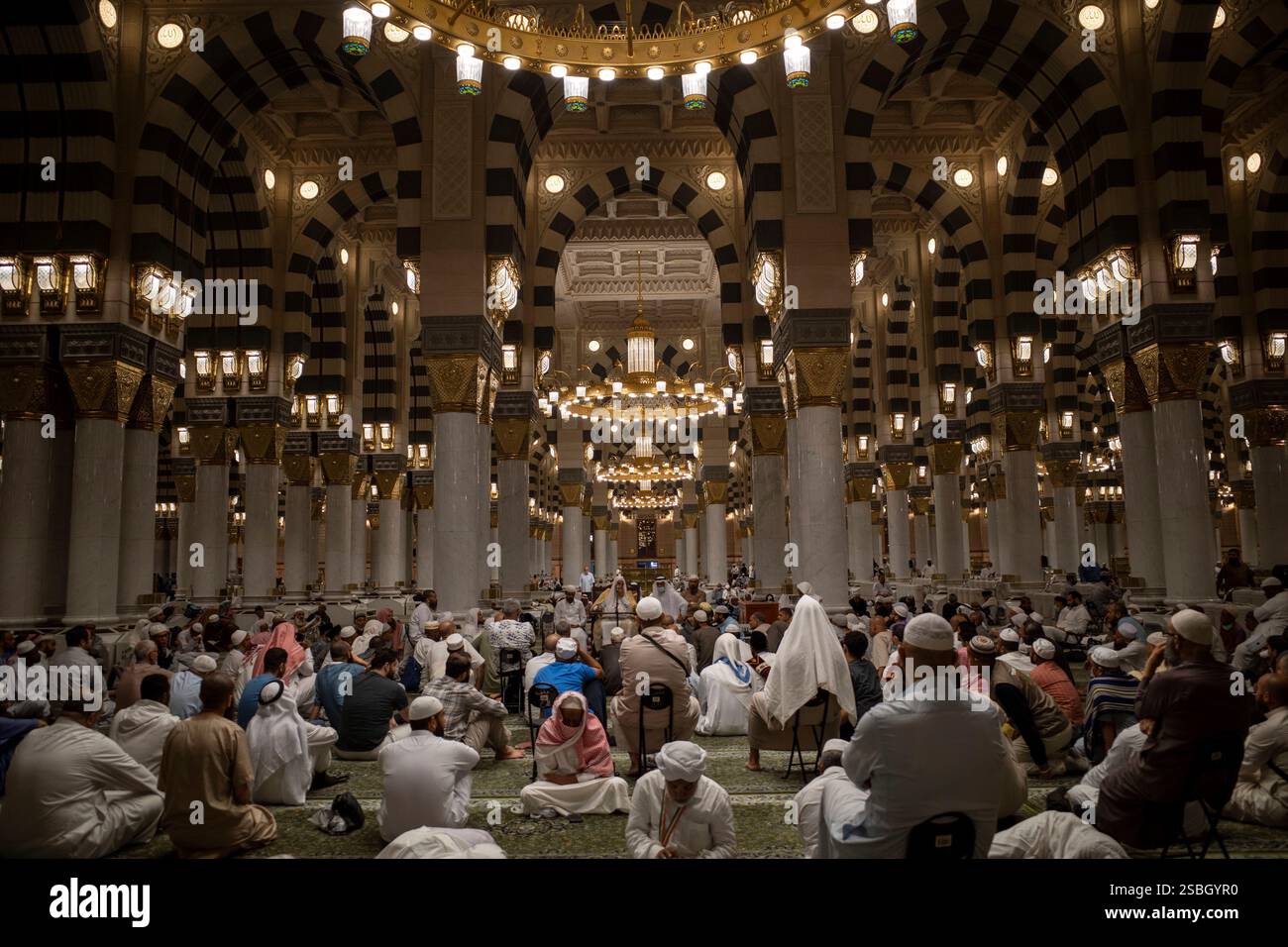 Medina, Saudi Arabia - July 5, 2024: Hajj pilgrims listening to a ...