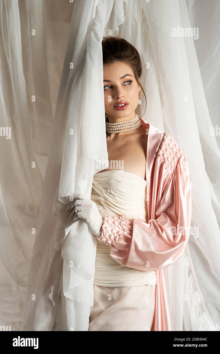 A lovely young woman in vintage attire poses gracefully with flowing ...