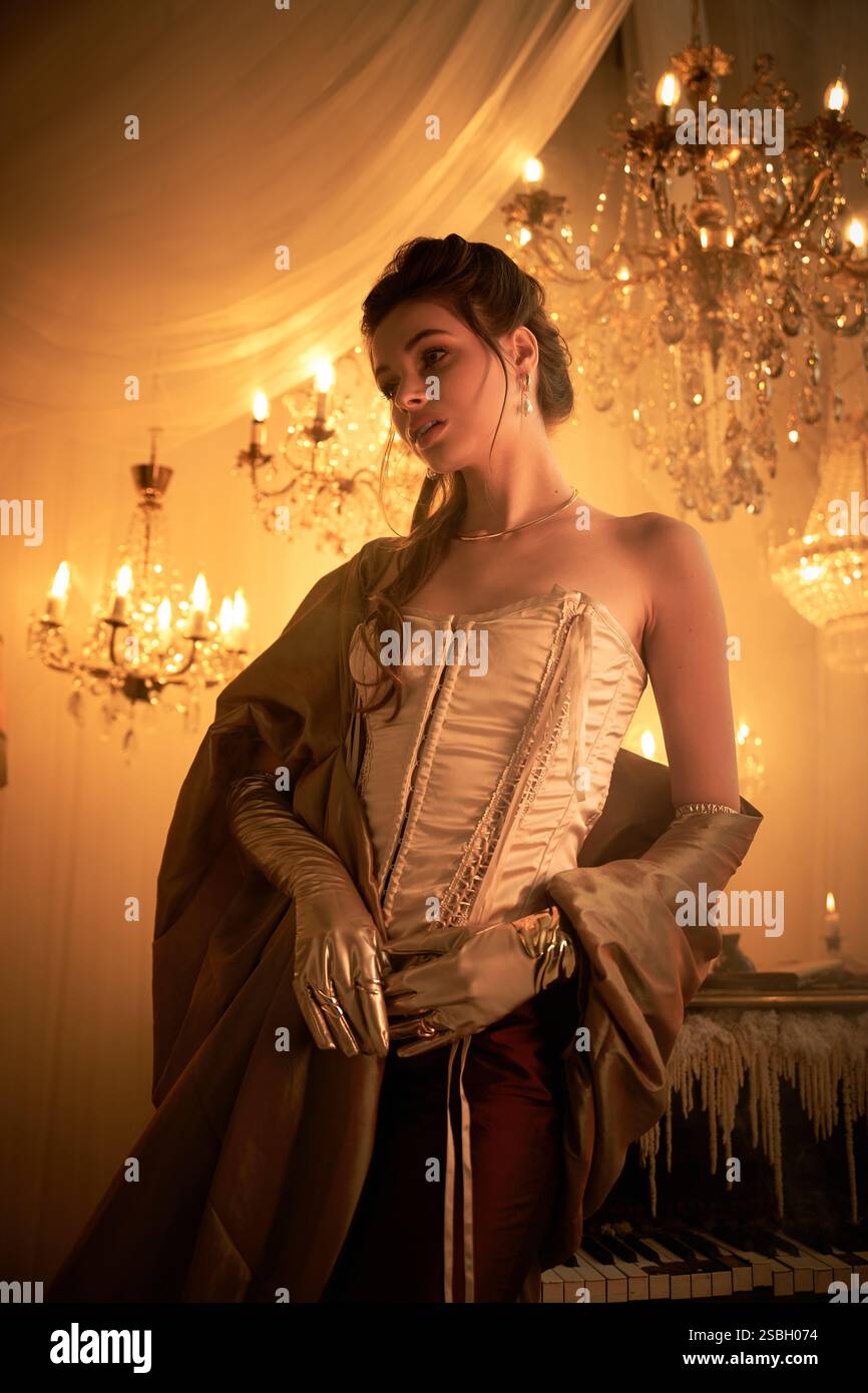 A beautiful young woman embodies a vampire in a lavish ballroom bathed ...