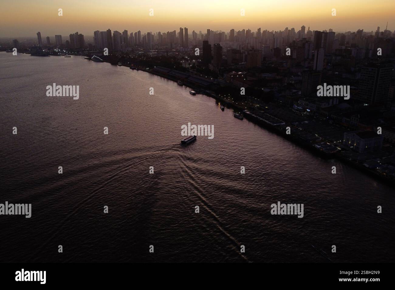 FILE - The sun rises over the bay of the Guama River in Belem, Brazil ...