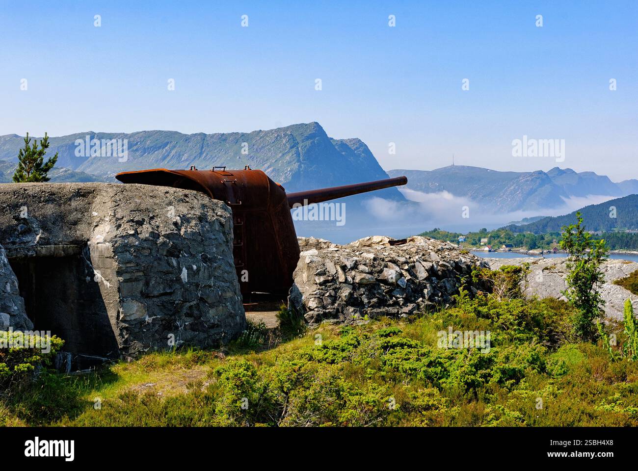 Rusting military artillery rests atop a coastal bunker, offering ...