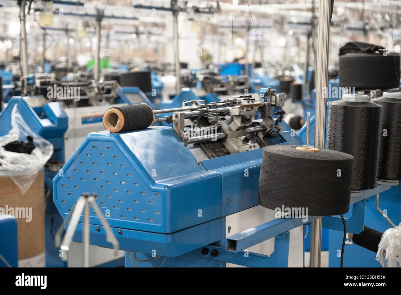 View of automated textile manufacturing machines in a factory, with ...