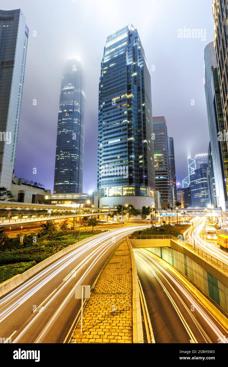 Hong Kong at night traffic with streets and skyscrapers downtown ...