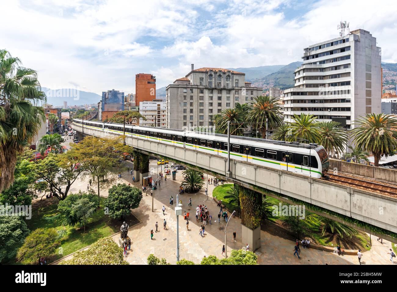 Medellin skyline with Metro de Medellín train at Plaza Botero square in ...