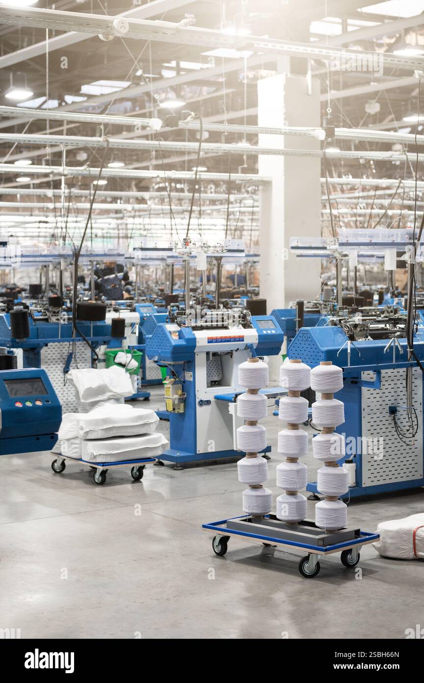 View of automated textile manufacturing machines in a factory, with ...