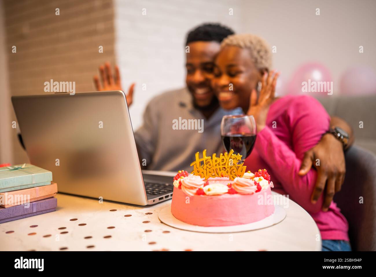 Happy young couple celebrating woman's birthday at home. They are ...