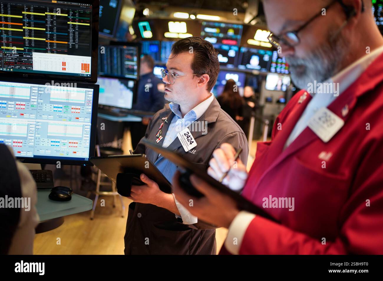 Traders work on the floor at the New York Stock Exchange in New York ...