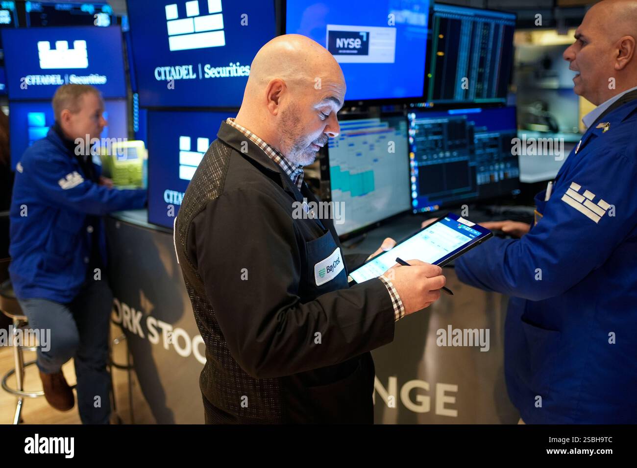 Traders work on the floor at the New York Stock Exchange in New York ...