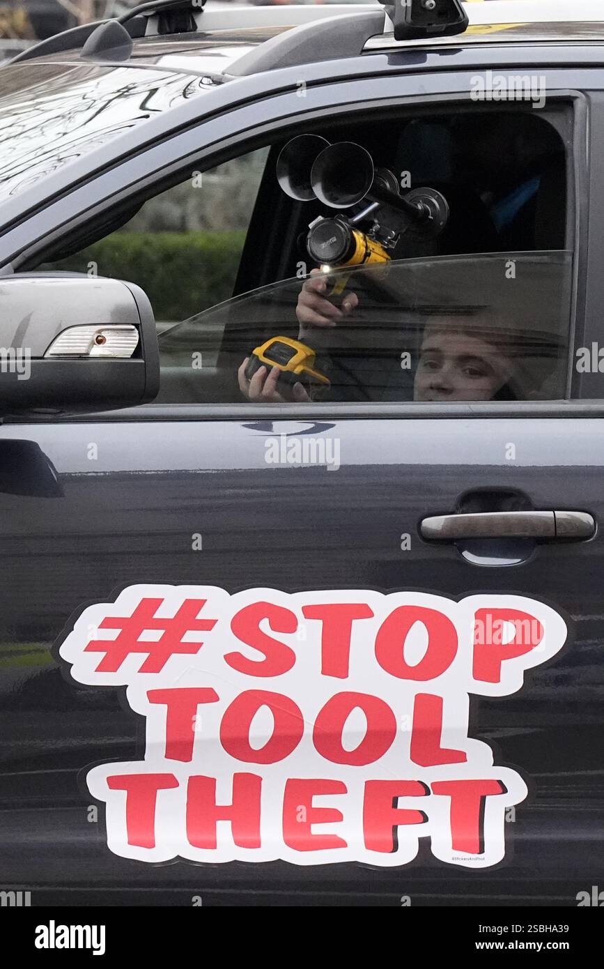 Vehicles take part in a slow drive protest against tool theft in ...