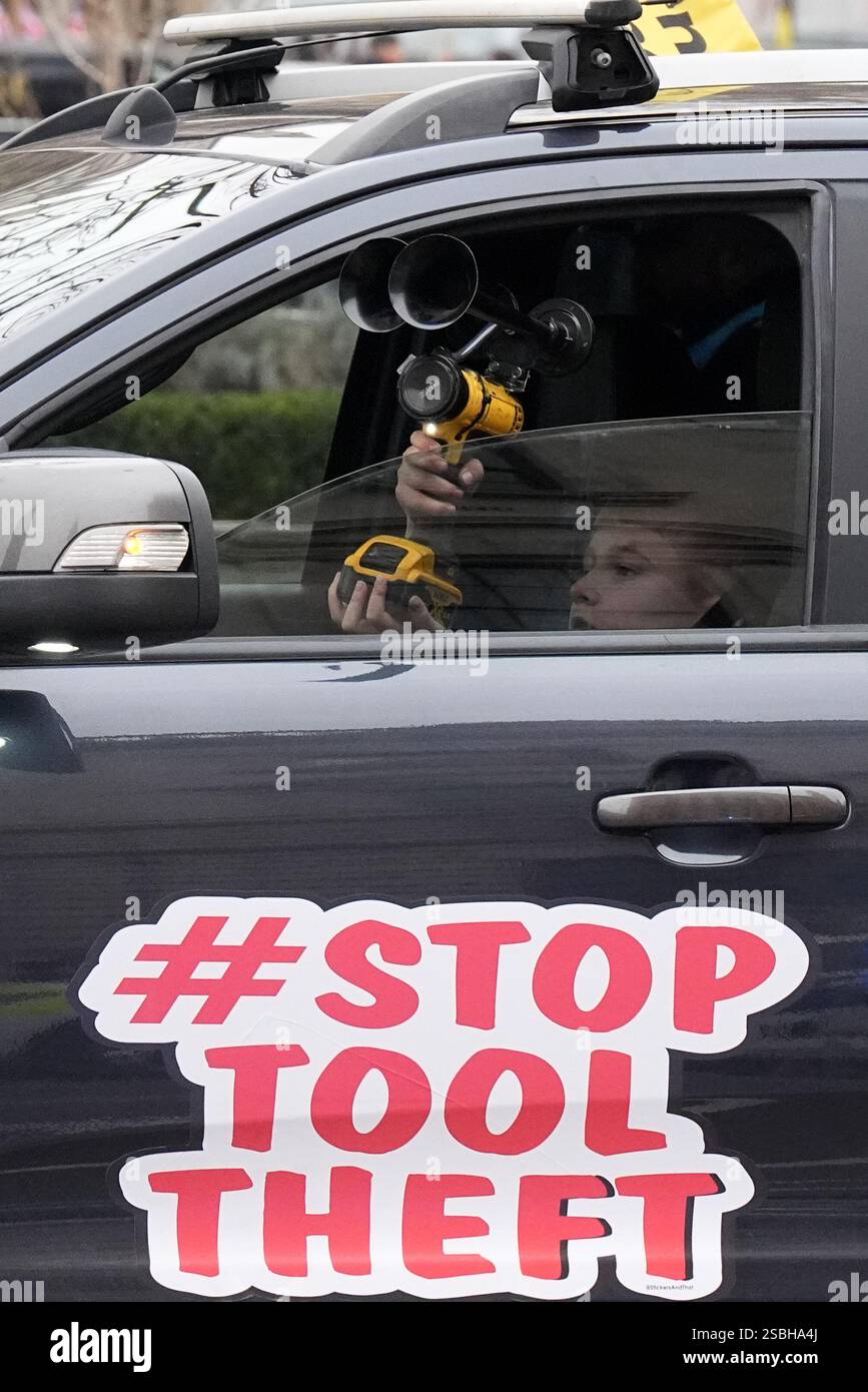 Vehicles take part in a slow drive protest against tool theft in ...