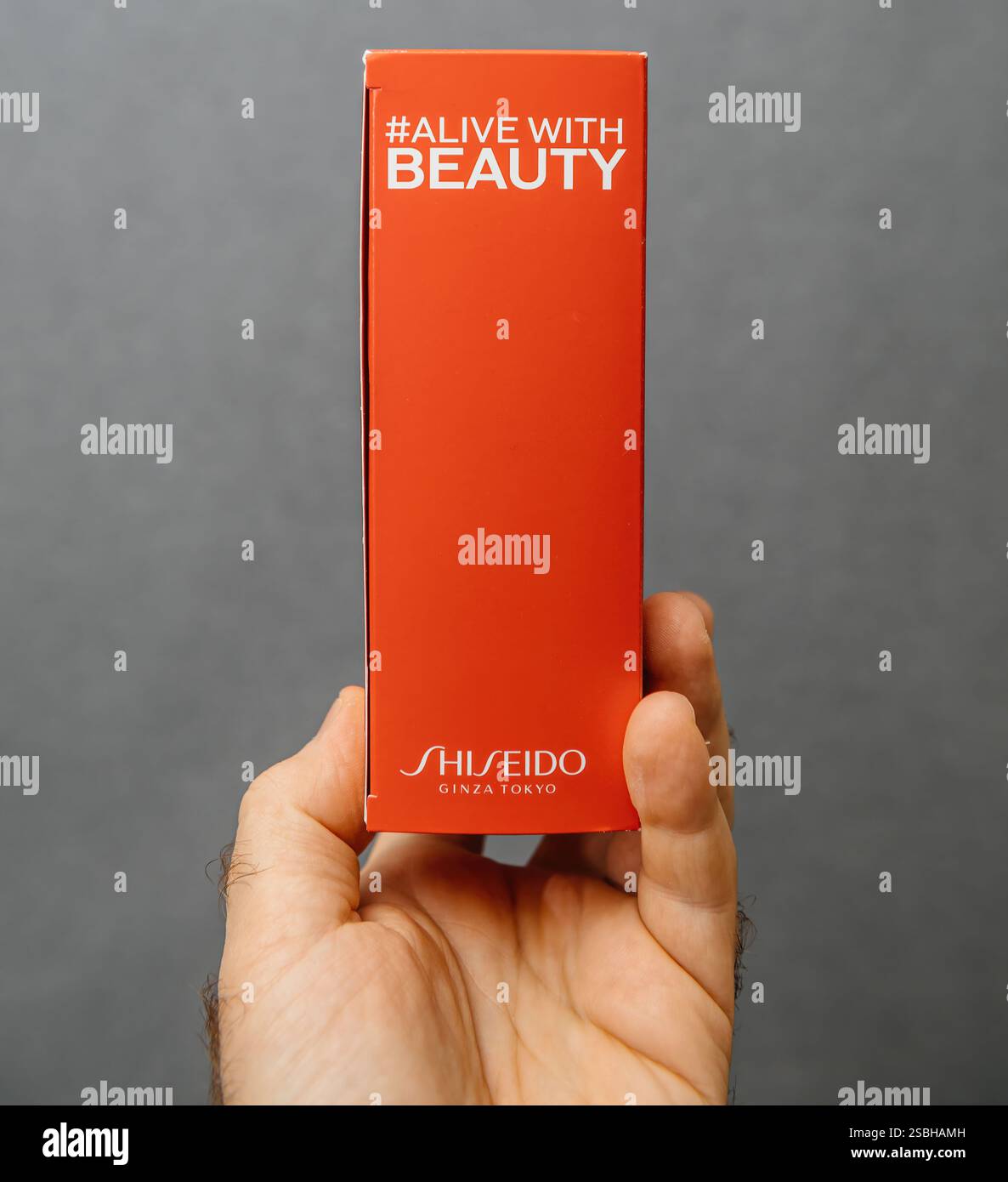 Paris, France - Jan 10, 2025: A hand displays a red Shiseido product ...