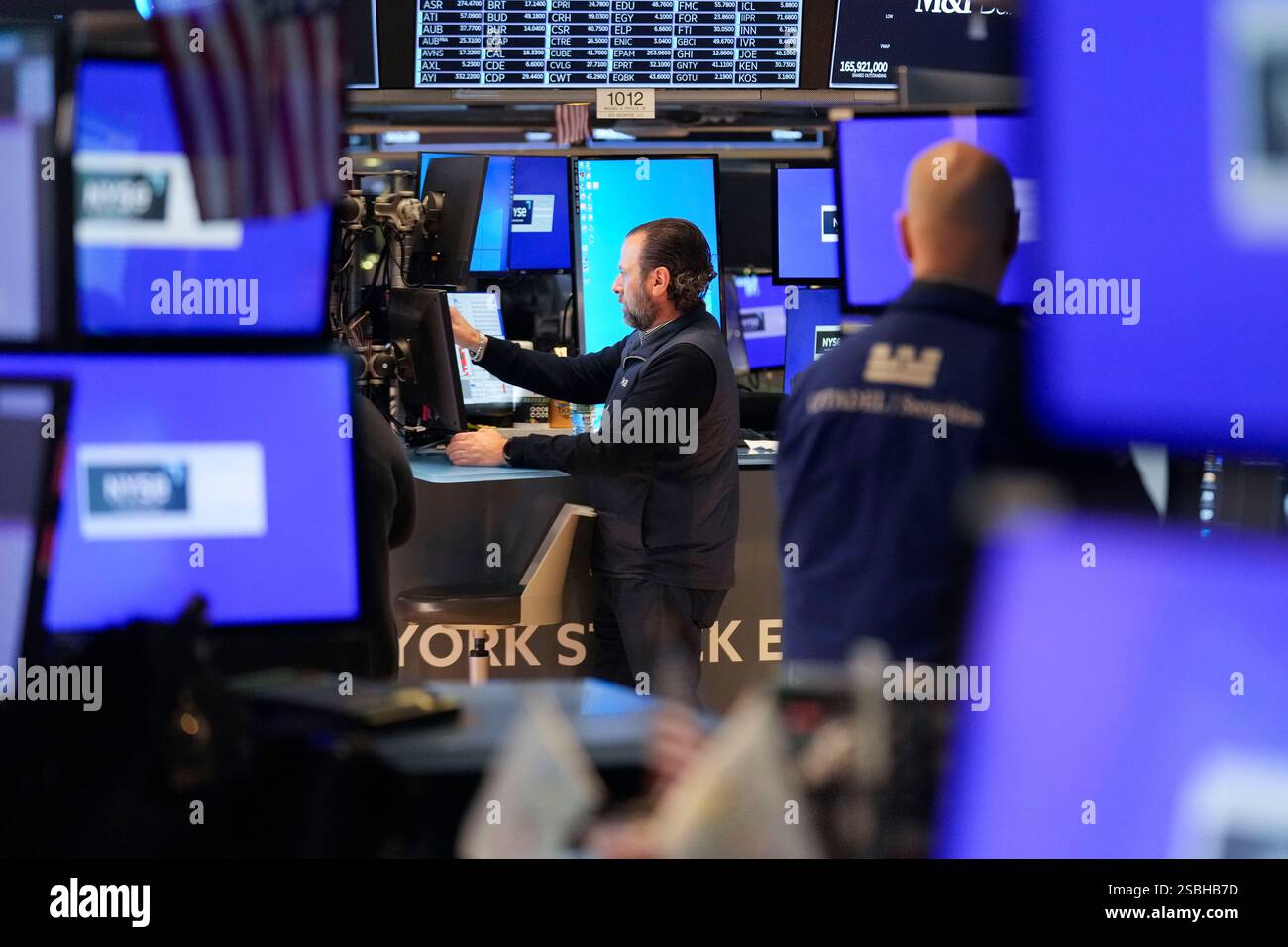 Traders work on the floor at the New York Stock Exchange in New York ...