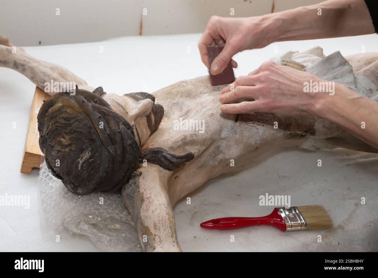 The restoration of Jesus Christ statue - detail of hands at work Stock ...