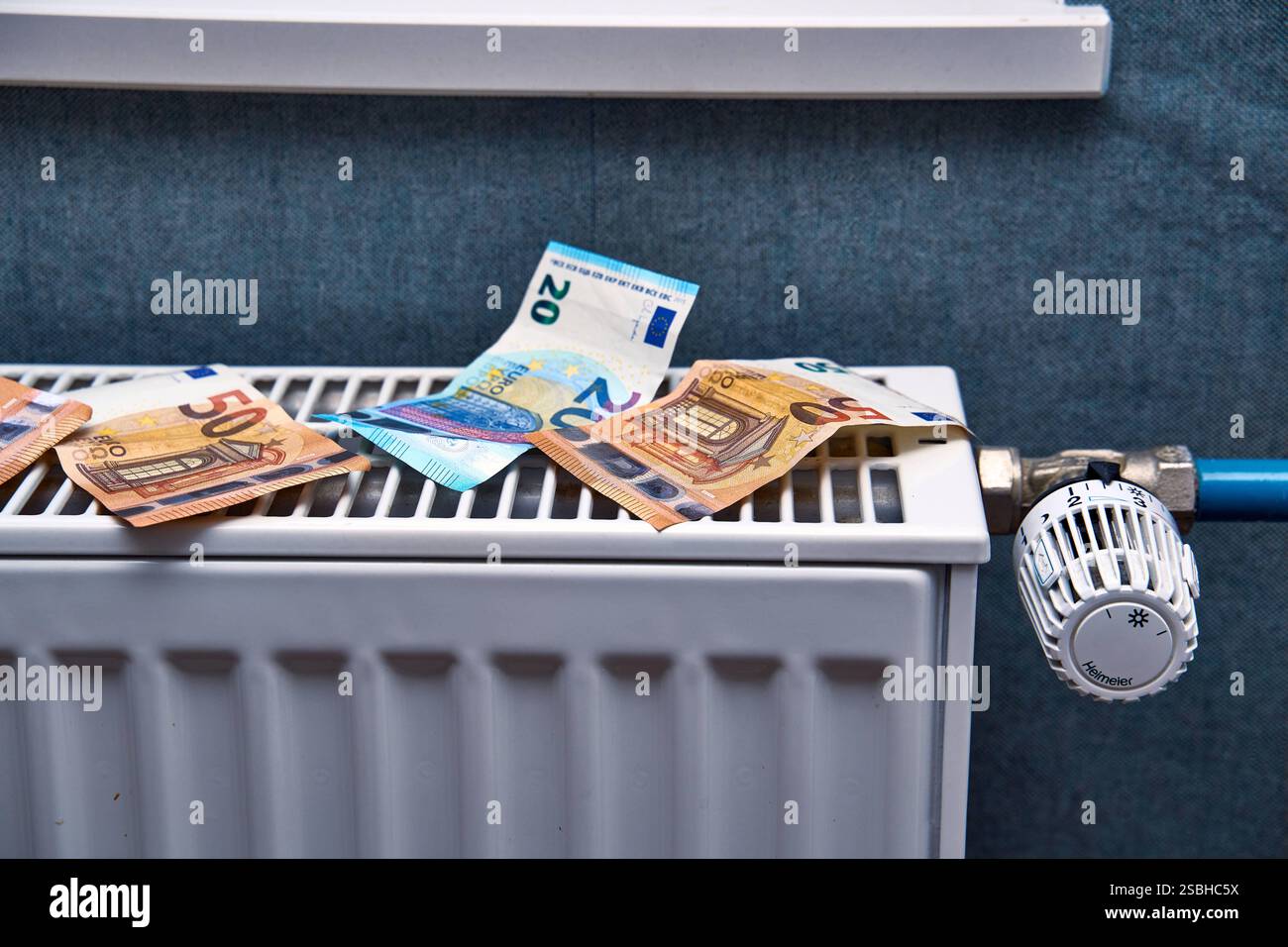 Bavaria, Germany - February 1, 2025: Euro banknotes lying on a radiator ...