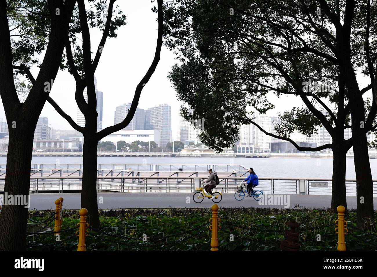 (250203) -- BEIJING, Feb. 3, 2025 (Xinhua) -- People ride bikes at Shanghai's World Expo culture ...