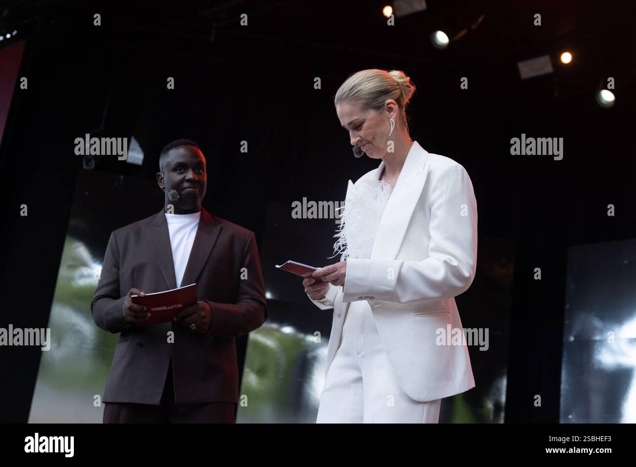 The hosts Melvin Kakooza (L) and Camilla Martin (R) seen on the stage ...