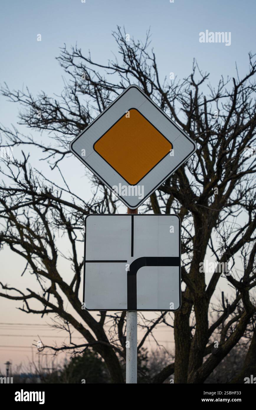 road sign the main road changes direction Stock Photo - Alamy