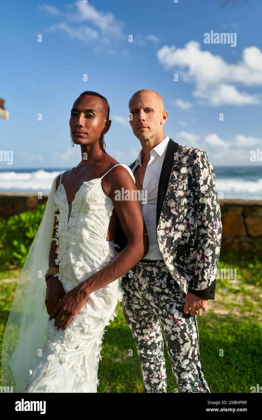 Gender fluid person in white dress, bold groom in floral suit at ...
